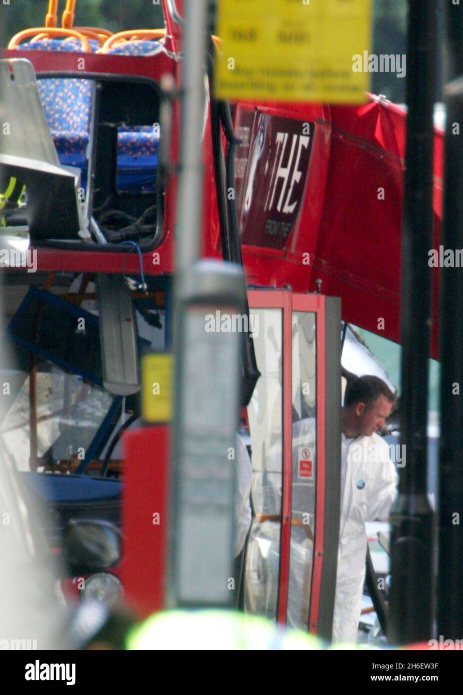 Forensic experts attend the scene of the number 30 bus which was blown ...