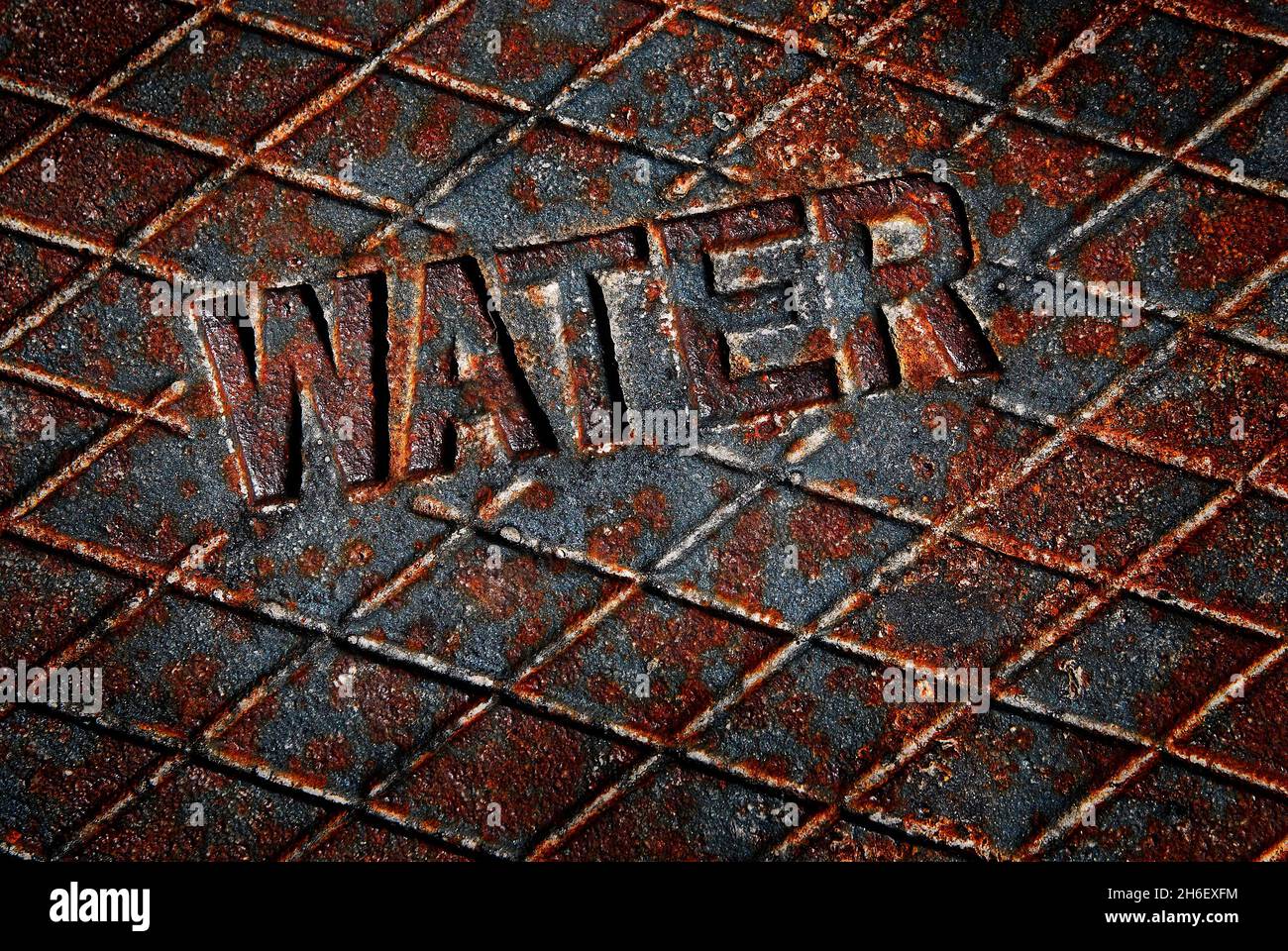 Iron lid or cover for water main line access or sewer Stock Photo - Alamy