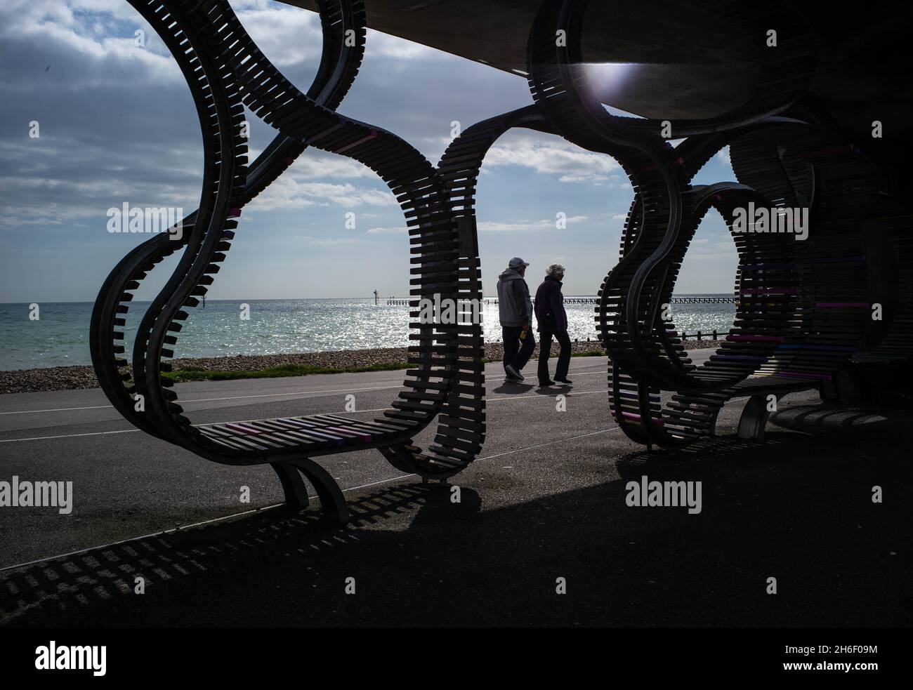 Members of the public walk past the The Long Bench at Littlehampton.The ...
