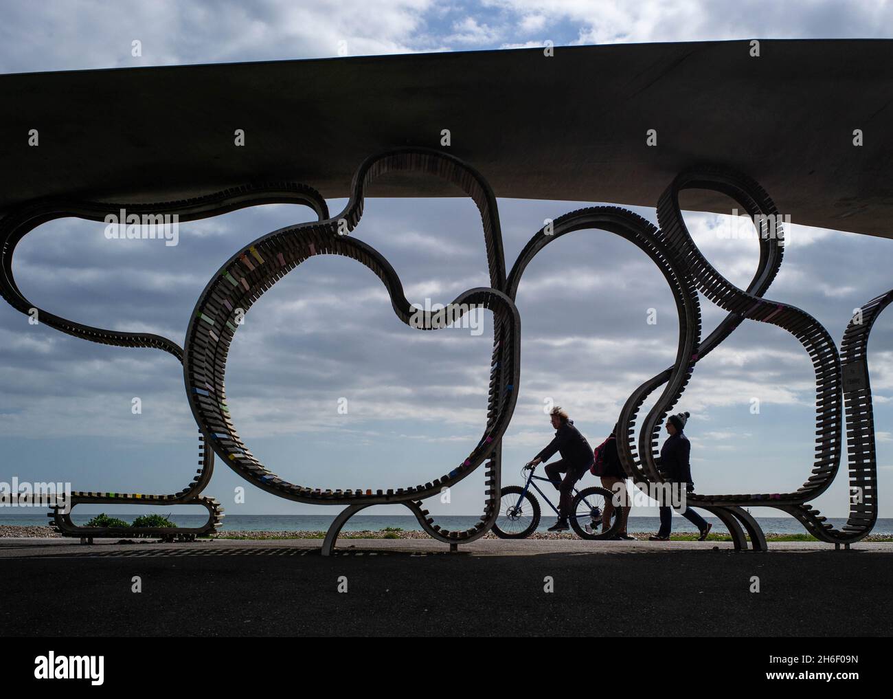 Members of the public walk past the The Long Bench at Littlehampton.The ...