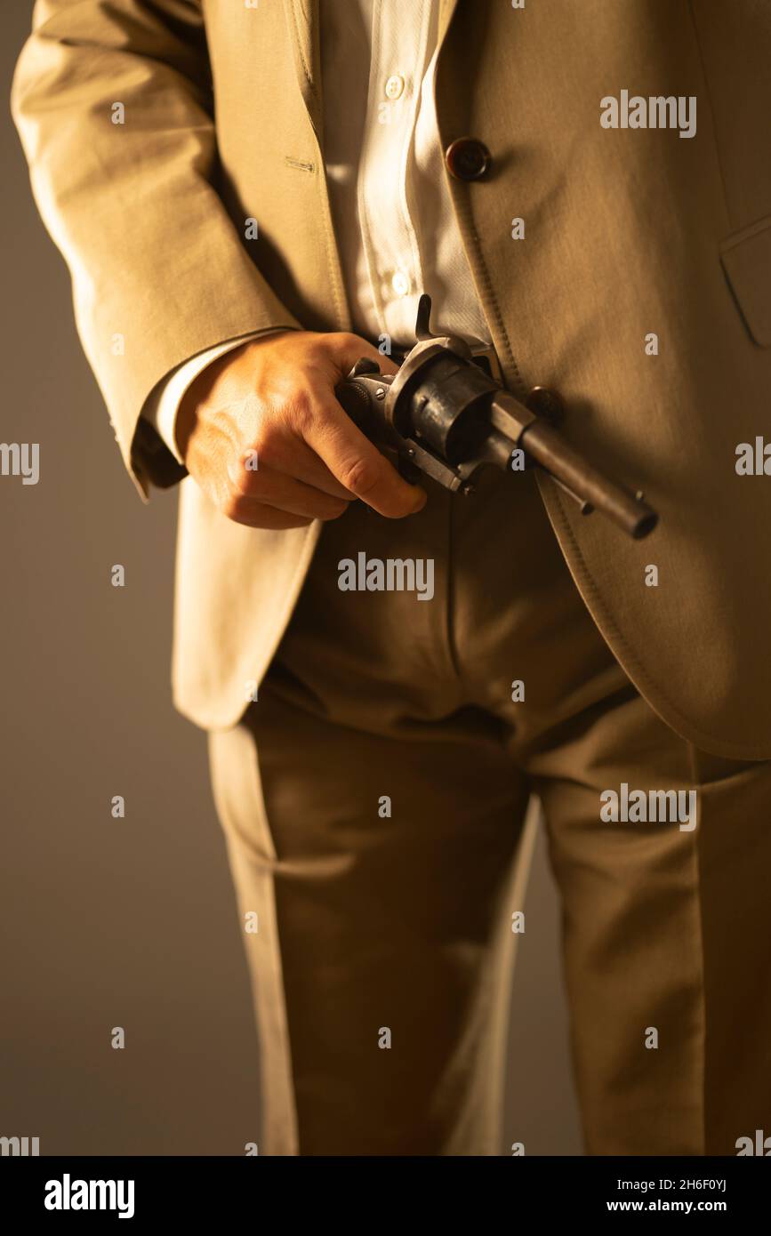 Male detective spy killer holding pistol gun in dramatic novel book ...
