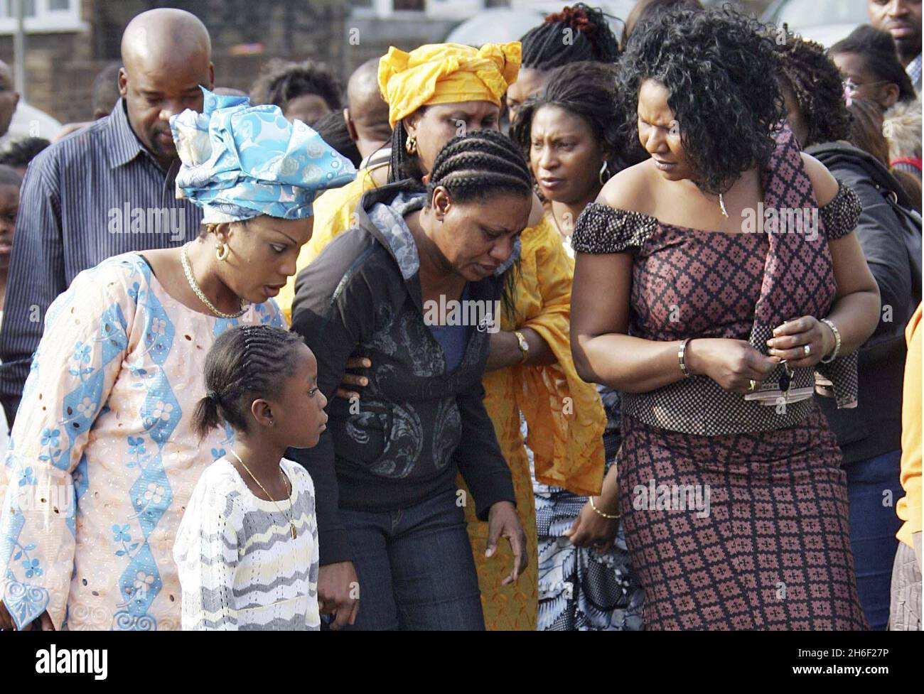 Ivie, the mother (centre) of 14 year old Paul Erhahon who was stabbed ...