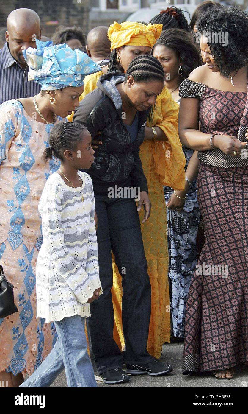 Ivie, the mother (centre) of 14 year old Paul Erhahon who was stabbed ...