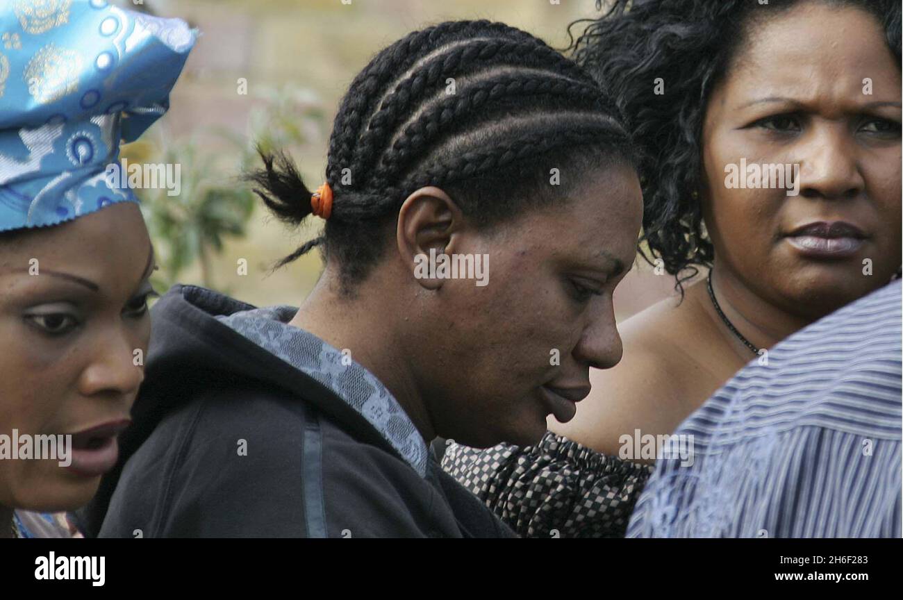 Ivie, the mother (centre) of 14 year old Paul Erhahon who was stabbed ...