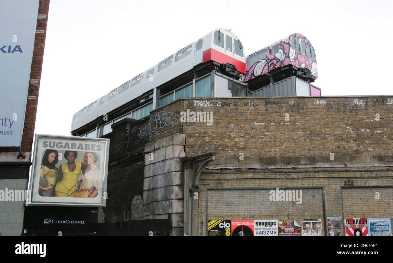 Two recycled London Underground train carriages are seen high above the ...