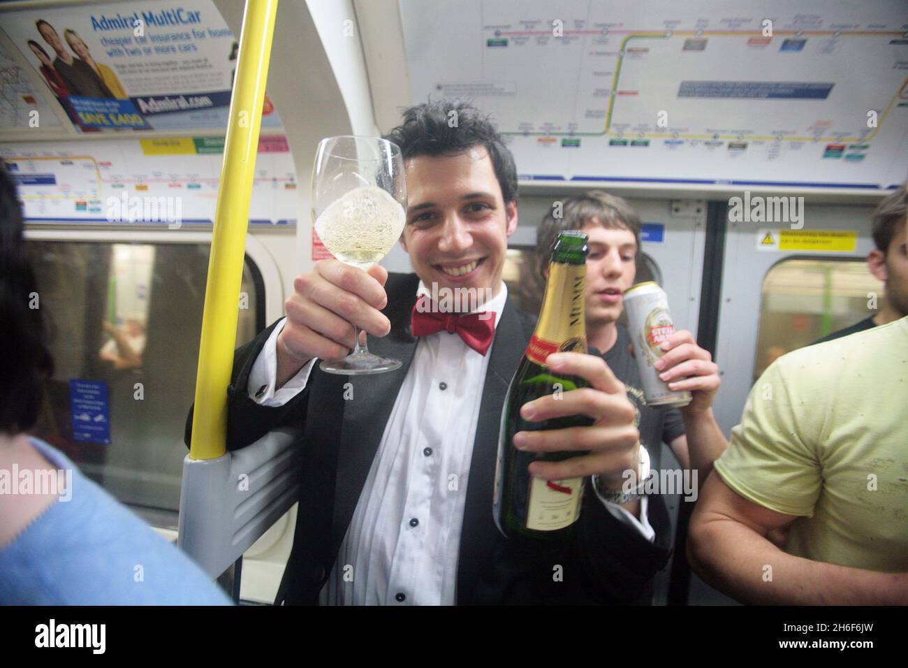 Revellers drink on a tube train, before the ban on drinking alcohol ...