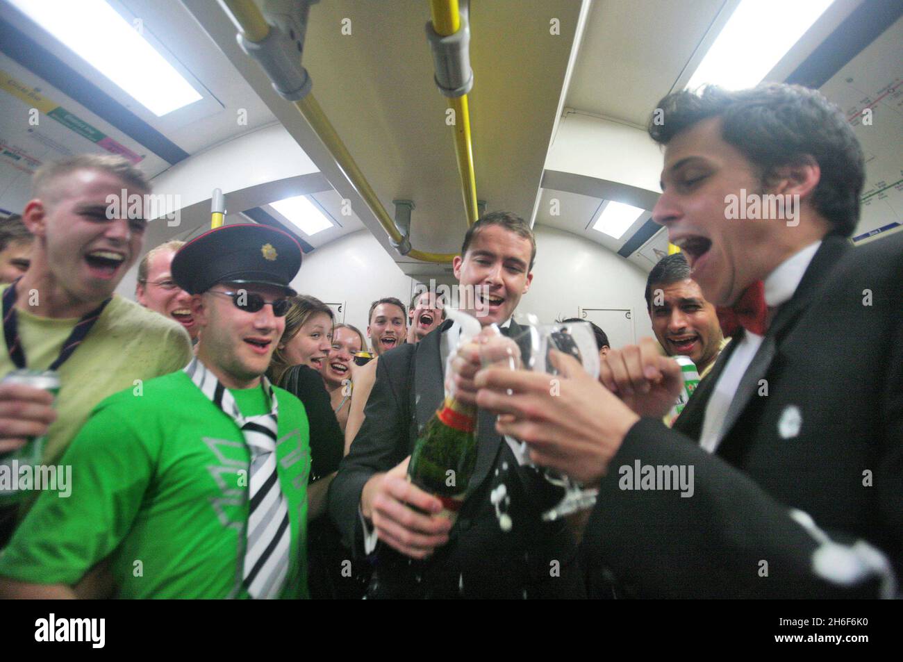 Revellers drink on a tube train, before the ban on drinking alcohol ...