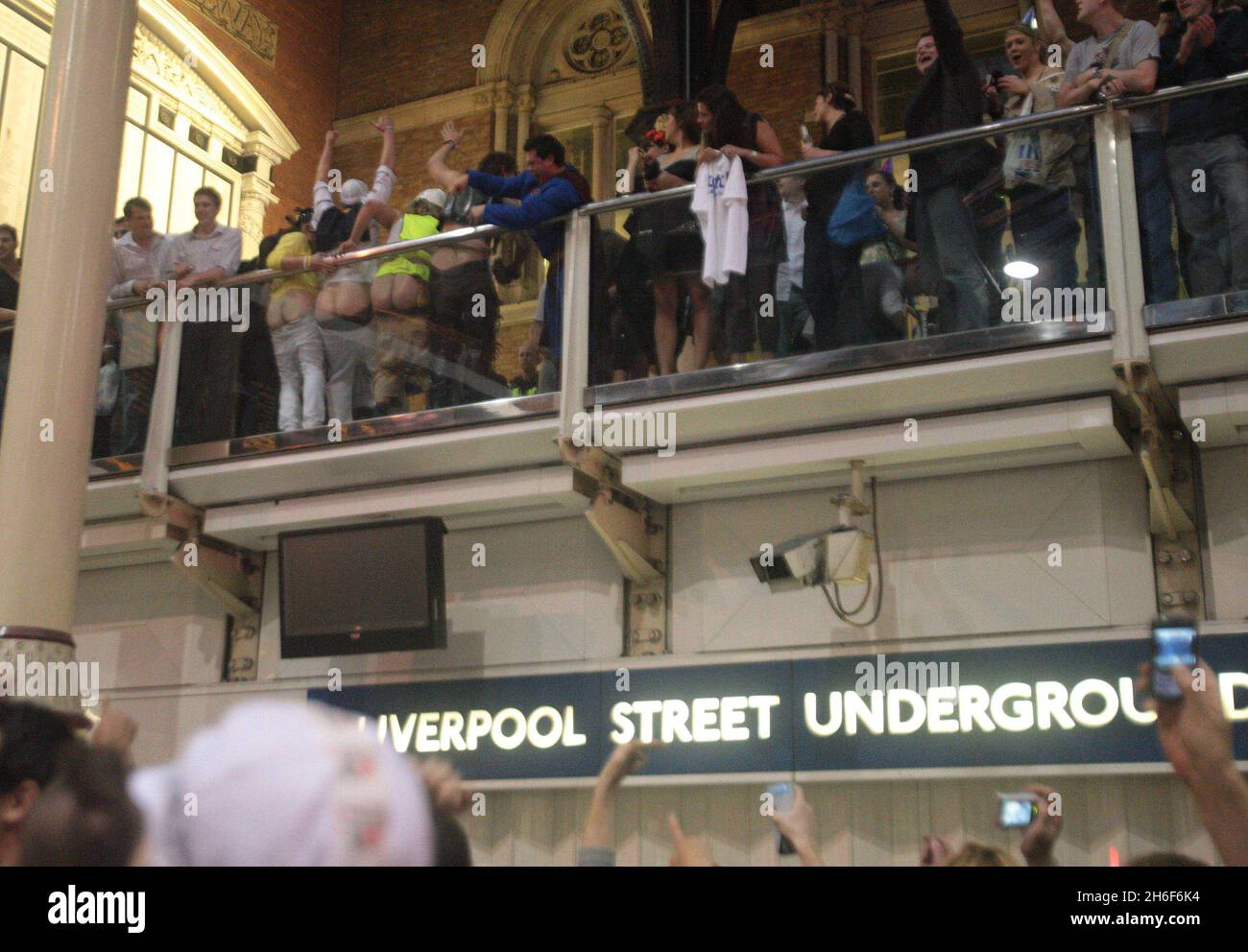 Revellers drink at Liverpool Street Station, before the ban on drinking ...