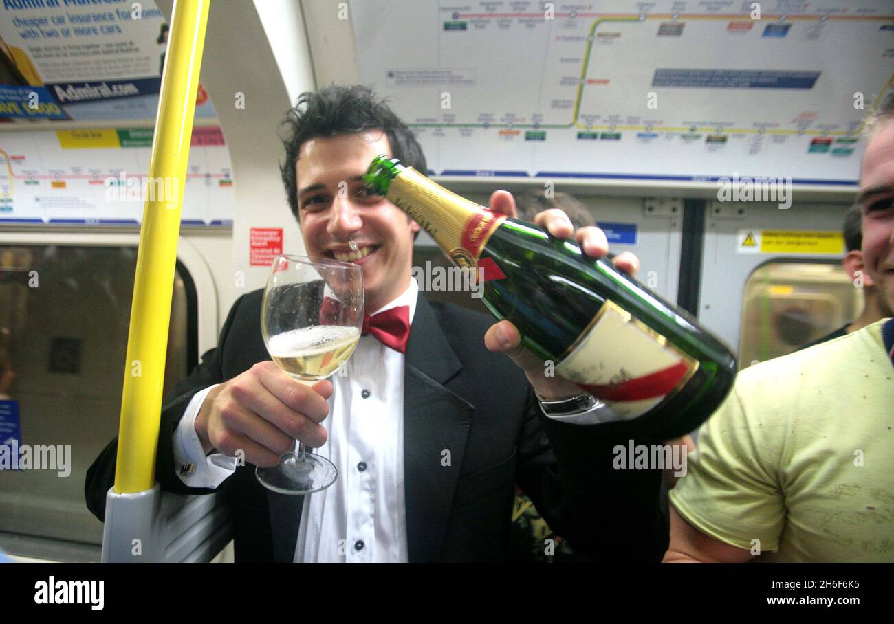Revellers drink on a tube train, before the ban on drinking alcohol ...