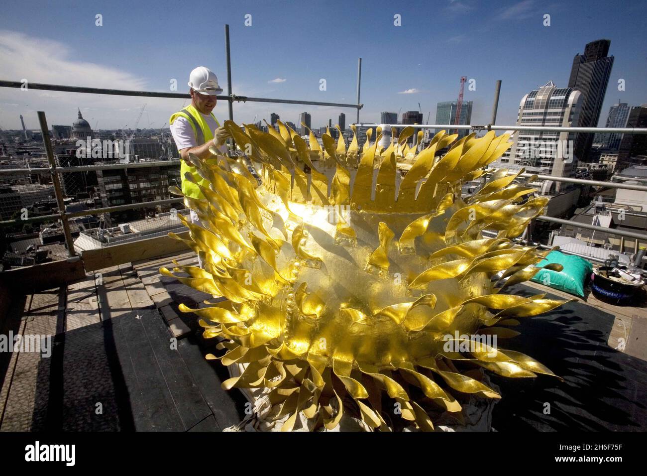 Restoration begins by gilding the famous flaming orb at the top of ...