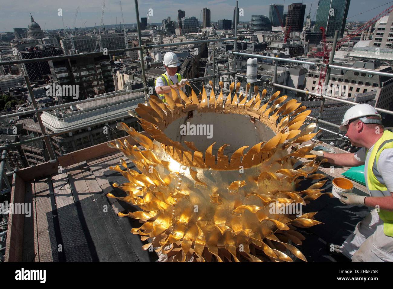 Restoration begins by gilding the famous flaming orb at the top of ...
