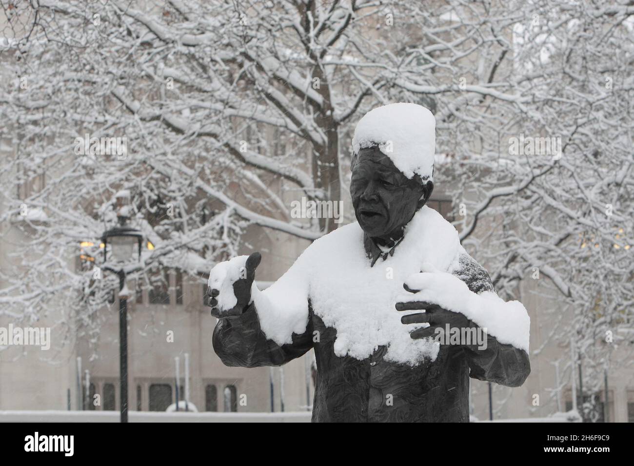 The Nelson Mandela statue in London's Parliament Square covered in snow ...