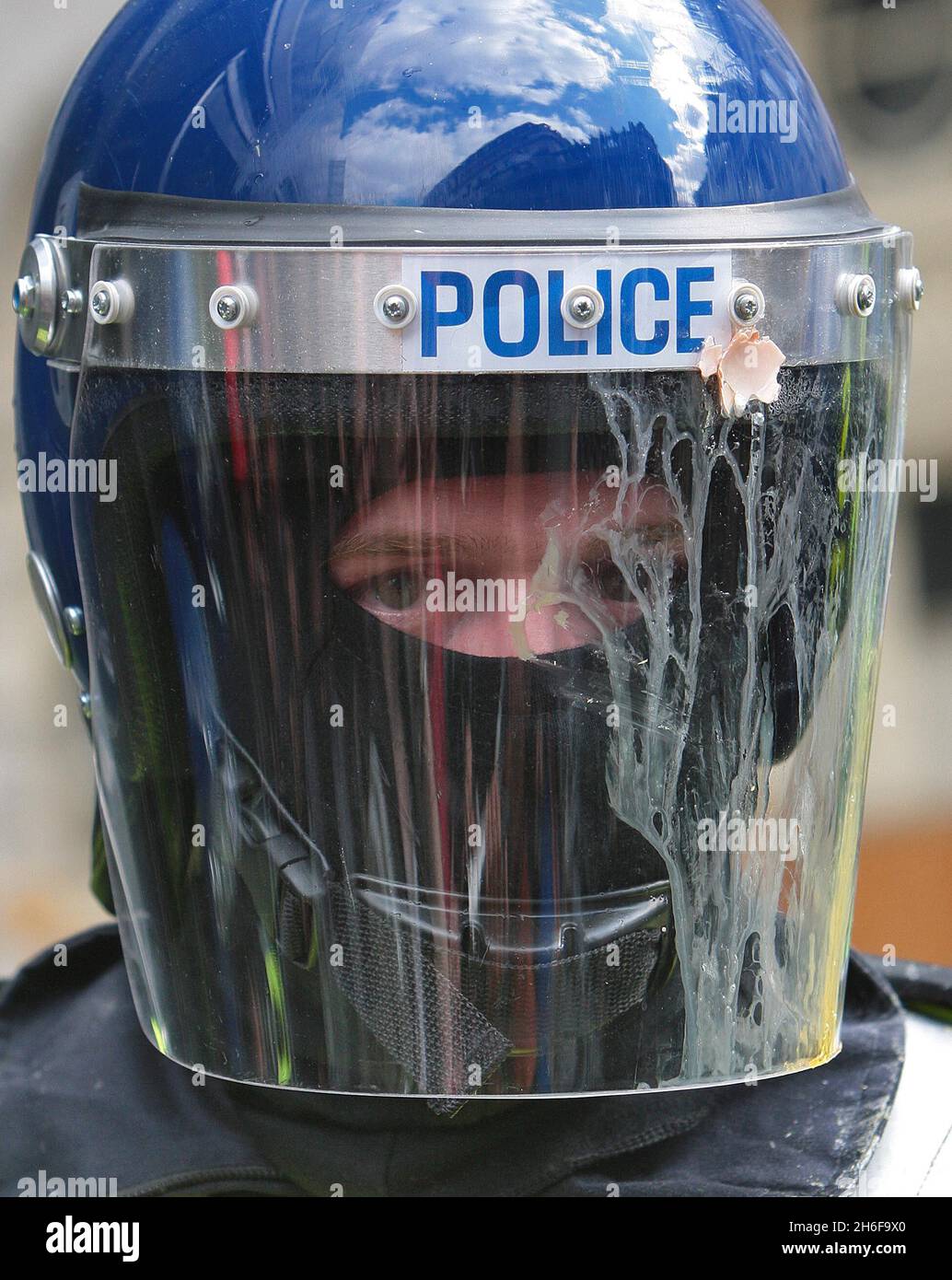 An egg is thrown at a riot police officer during the G20 protest at the ...