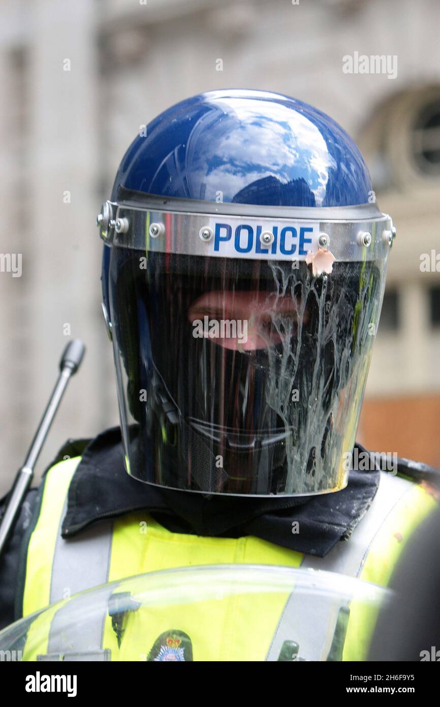 An egg is thrown at a riot police officer during the G20 protest at the ...