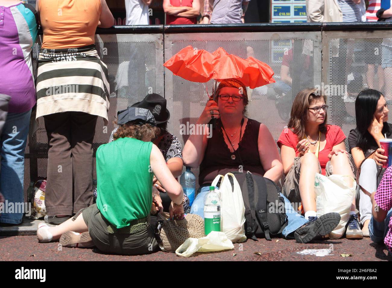 Johnny Depp fans queue in the heat outside the Empire cinema in London ...