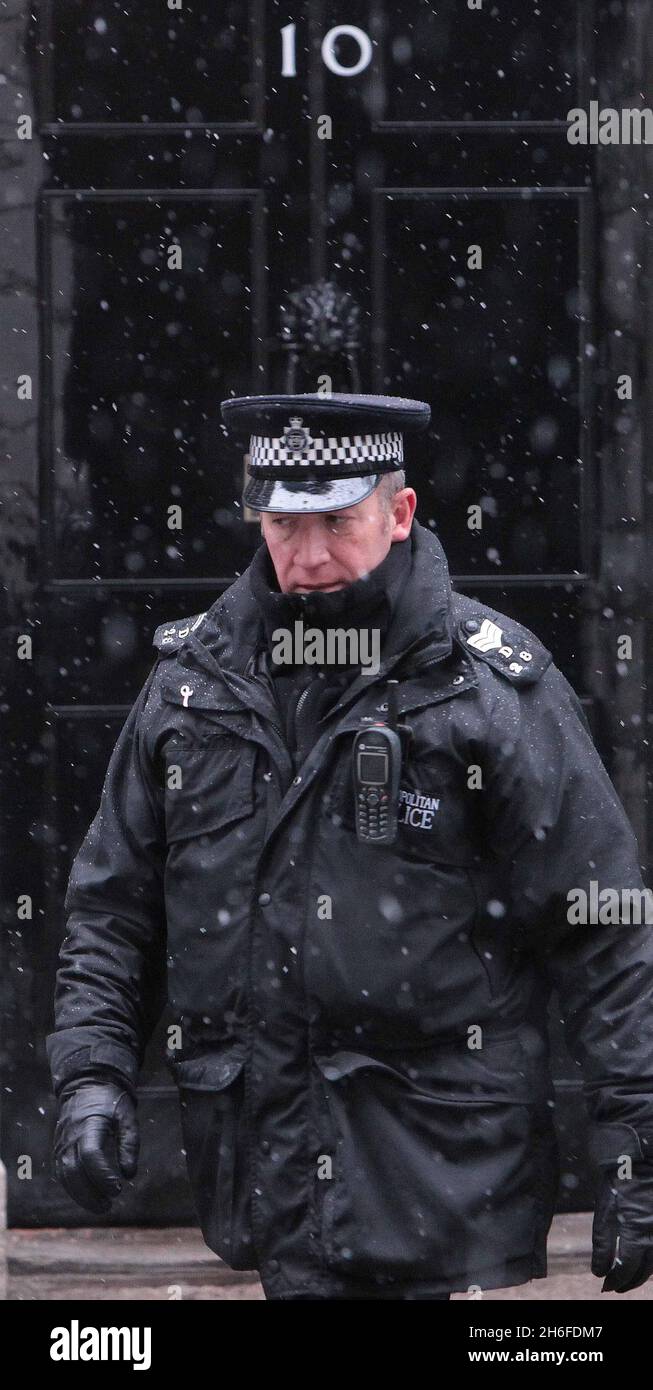 A police officer pictured in the snow in Downing Street today Stock ...