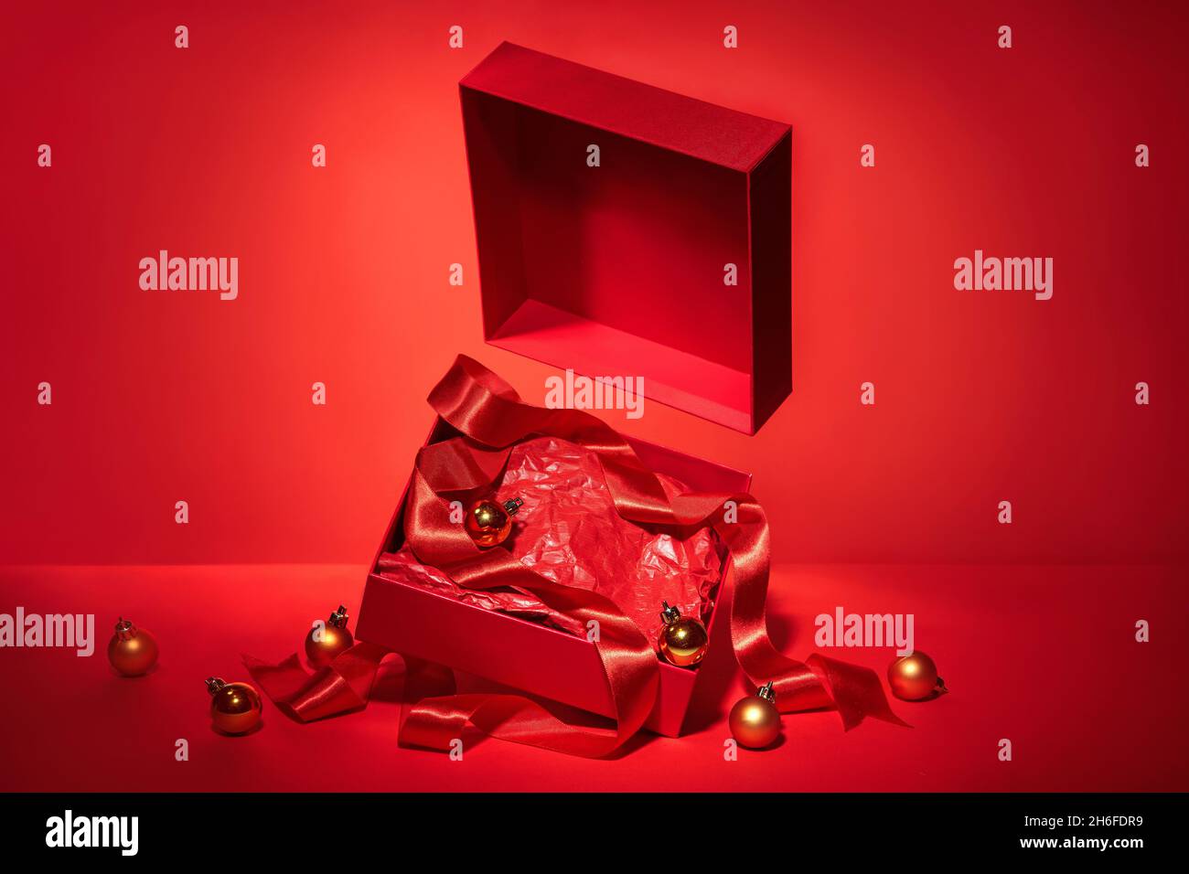 Blank open red holiday gift box with ribbon and Christmas decor. Layout ...