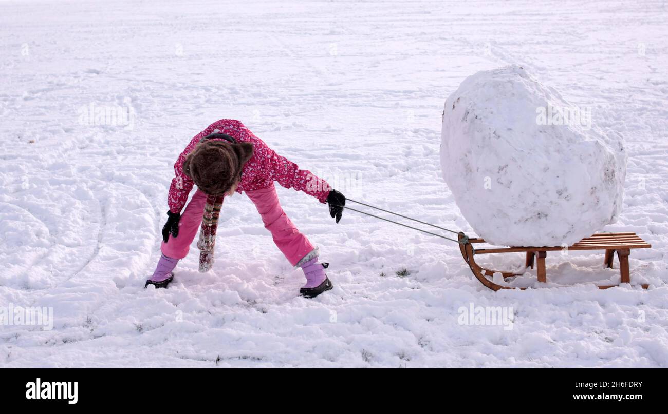 Jessie, aged 10, enjoys the day off school in the snow on Wanstead ...