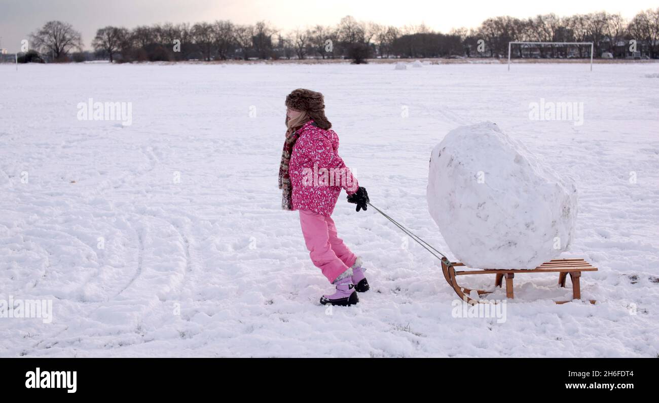 Jessie, aged 10, enjoys the day off school in the snow on Wanstead ...