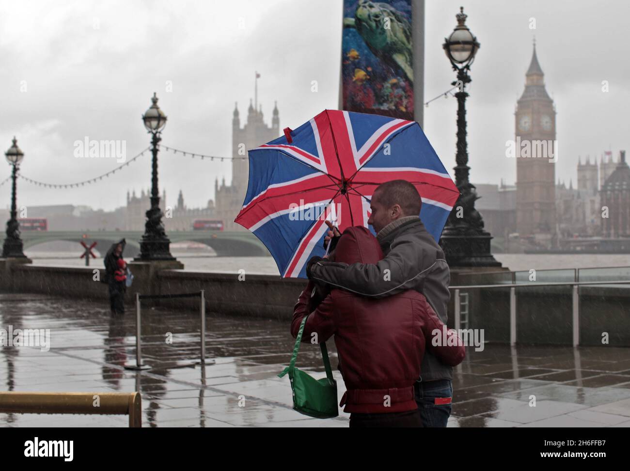 Heavy rain hit London this afternoon. Picture shows: Tourists caught in ...