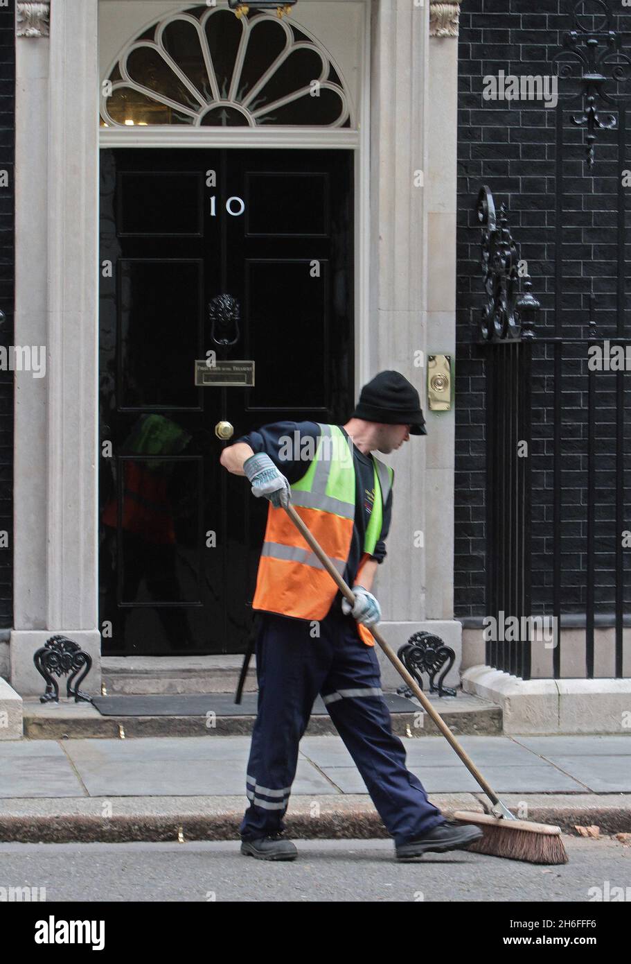 A cleaner sweeps up outside No.10 before PM Gordon Brown leaves Downing ...
