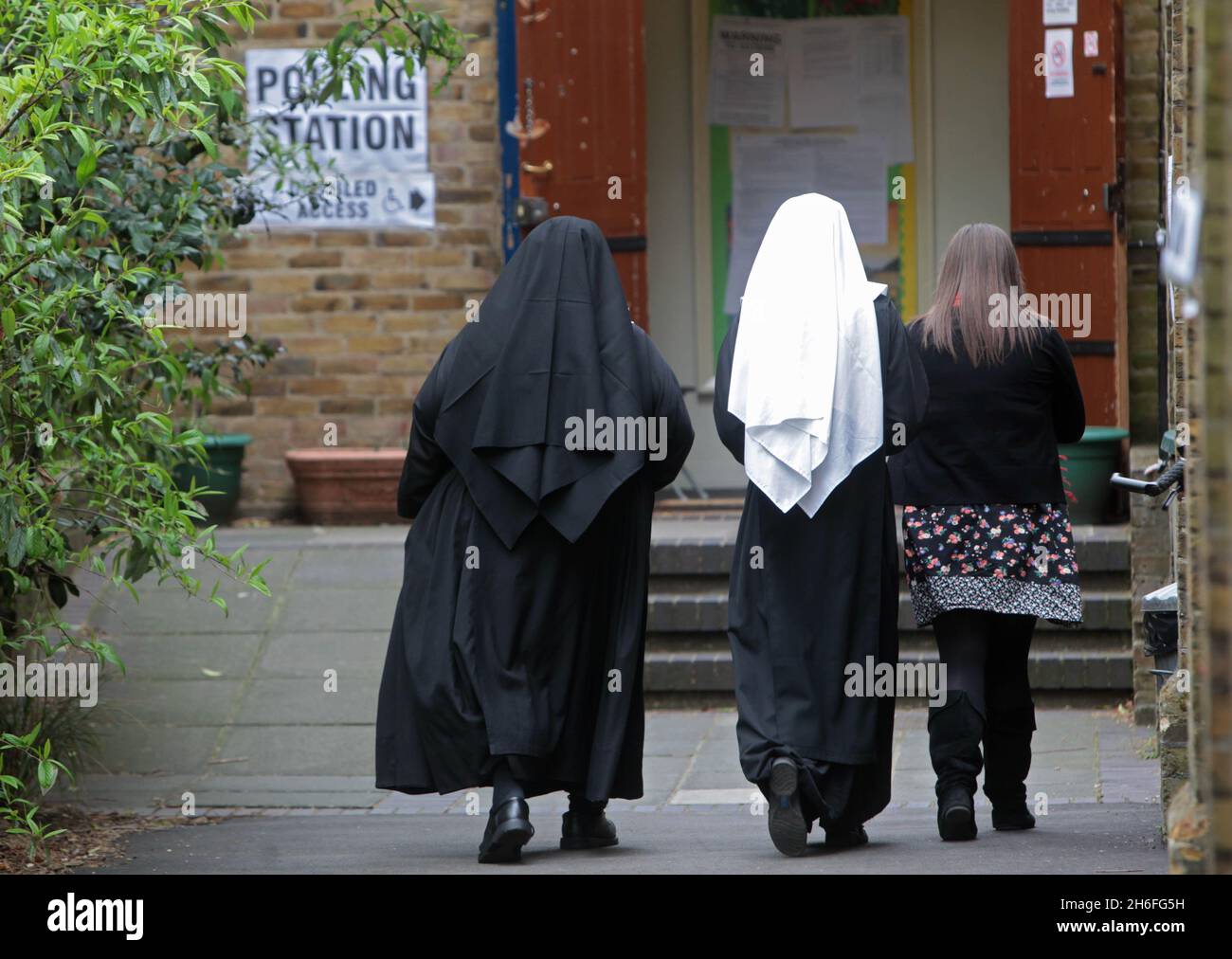 Nuns arrive at a polling station at St John's Parish church in central ...