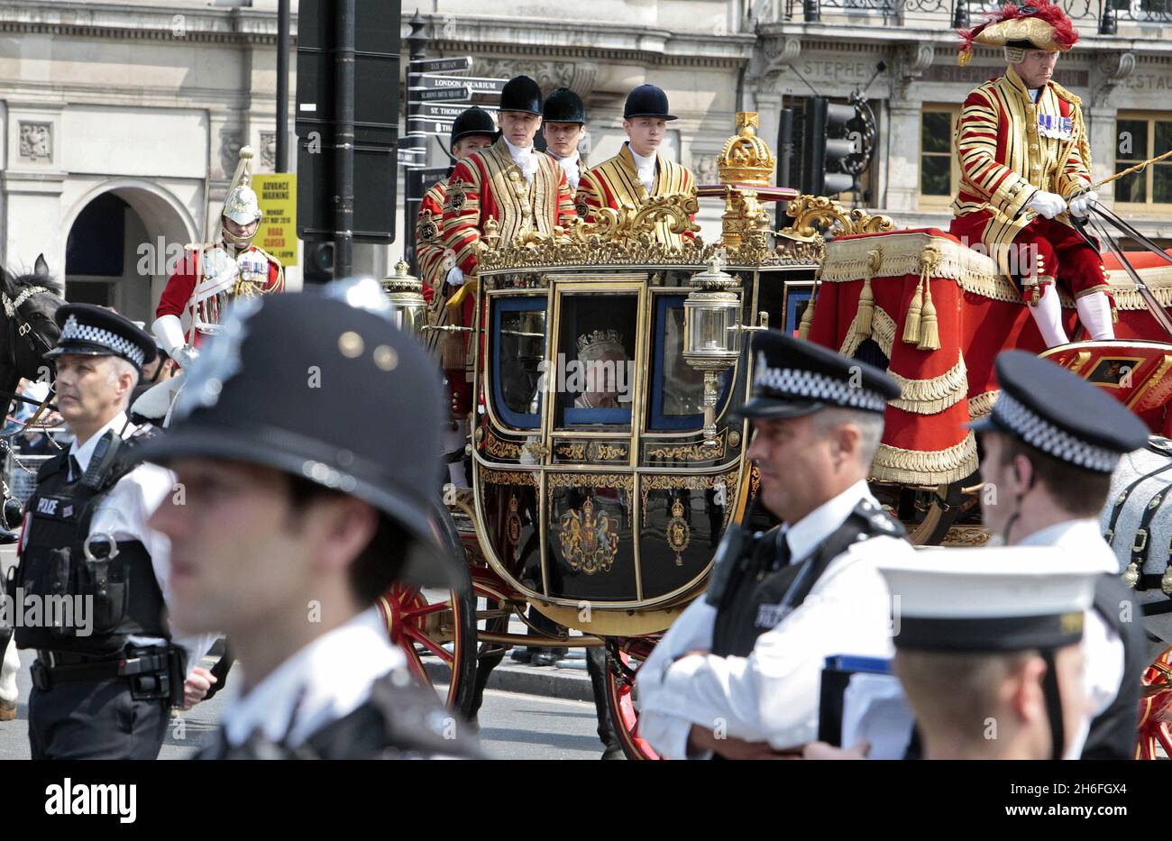 The Queen arrives among police officers in Westminster for the State ...