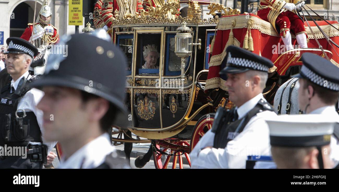 The Queen arrives among police officers in Westminster for the State ...