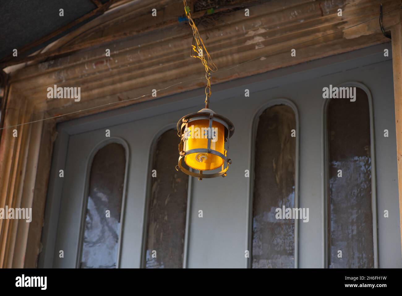 a flashlight with yellow glass hanging over the door Stock Photo - Alamy