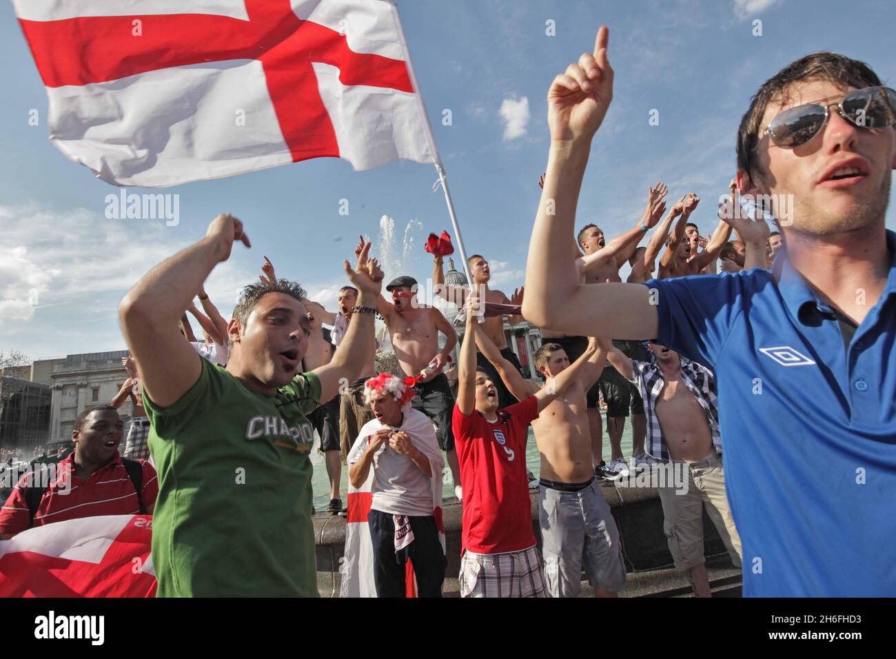 England football fans cool off in the fountains at Trafalgar Square ...