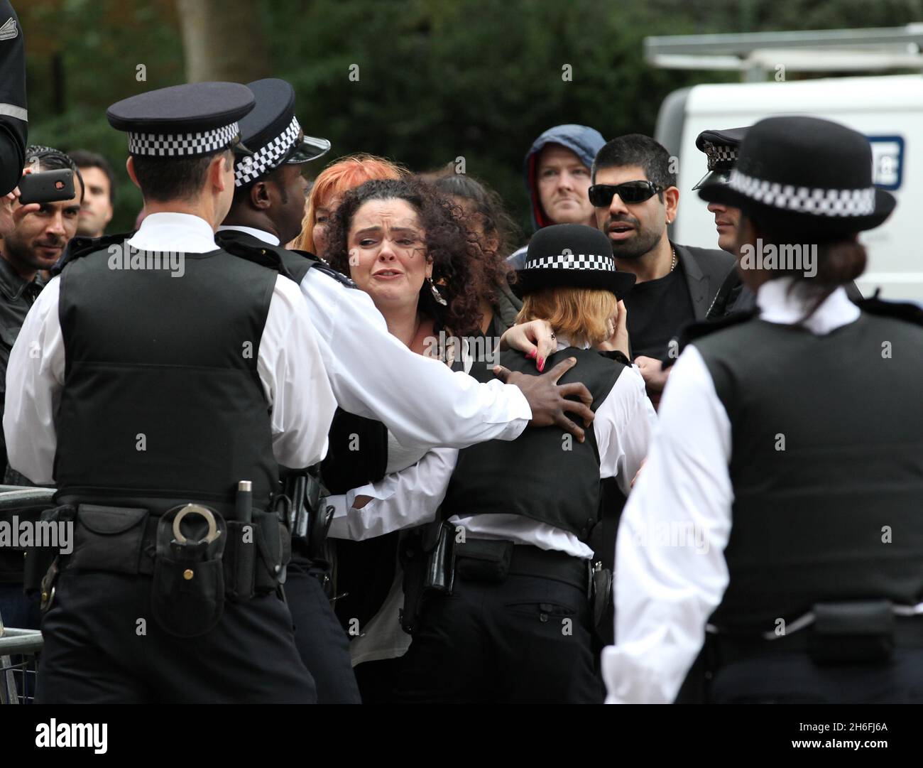 Police hold back fans as pop star George Michael arrives at Highbury ...