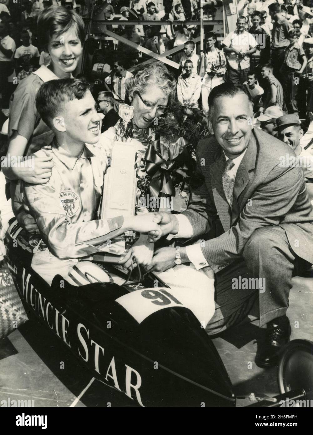 James Miley, winner of the 1958 Soap Box Derby receives the trophy from ...