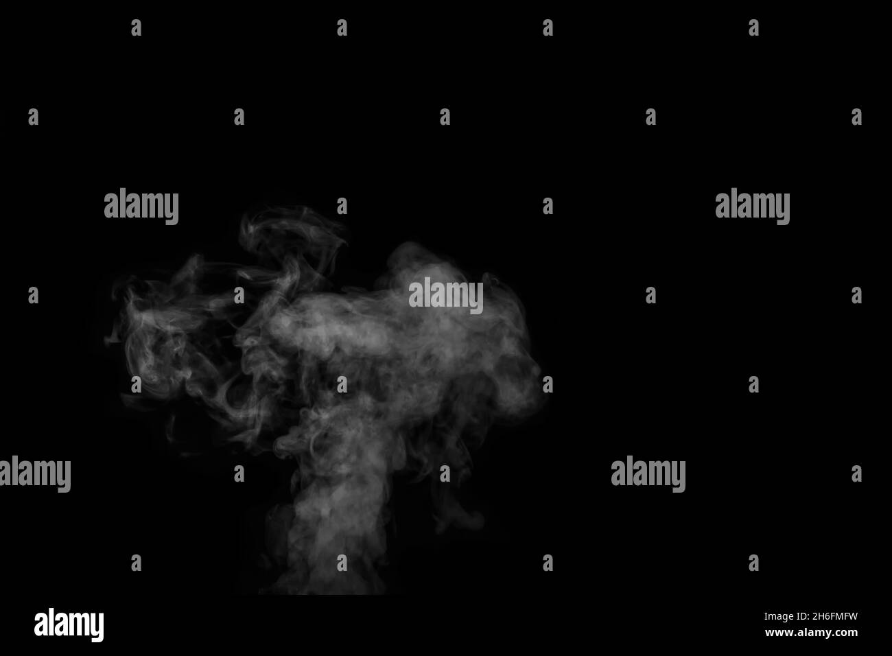 White vapor spray steam from air saturator. Smoke fragments on a black ...