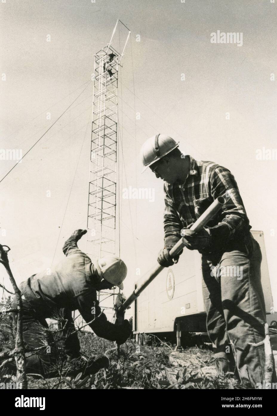 Men at work on a long-distance telephone station tower, USA 1964 Stock ...
