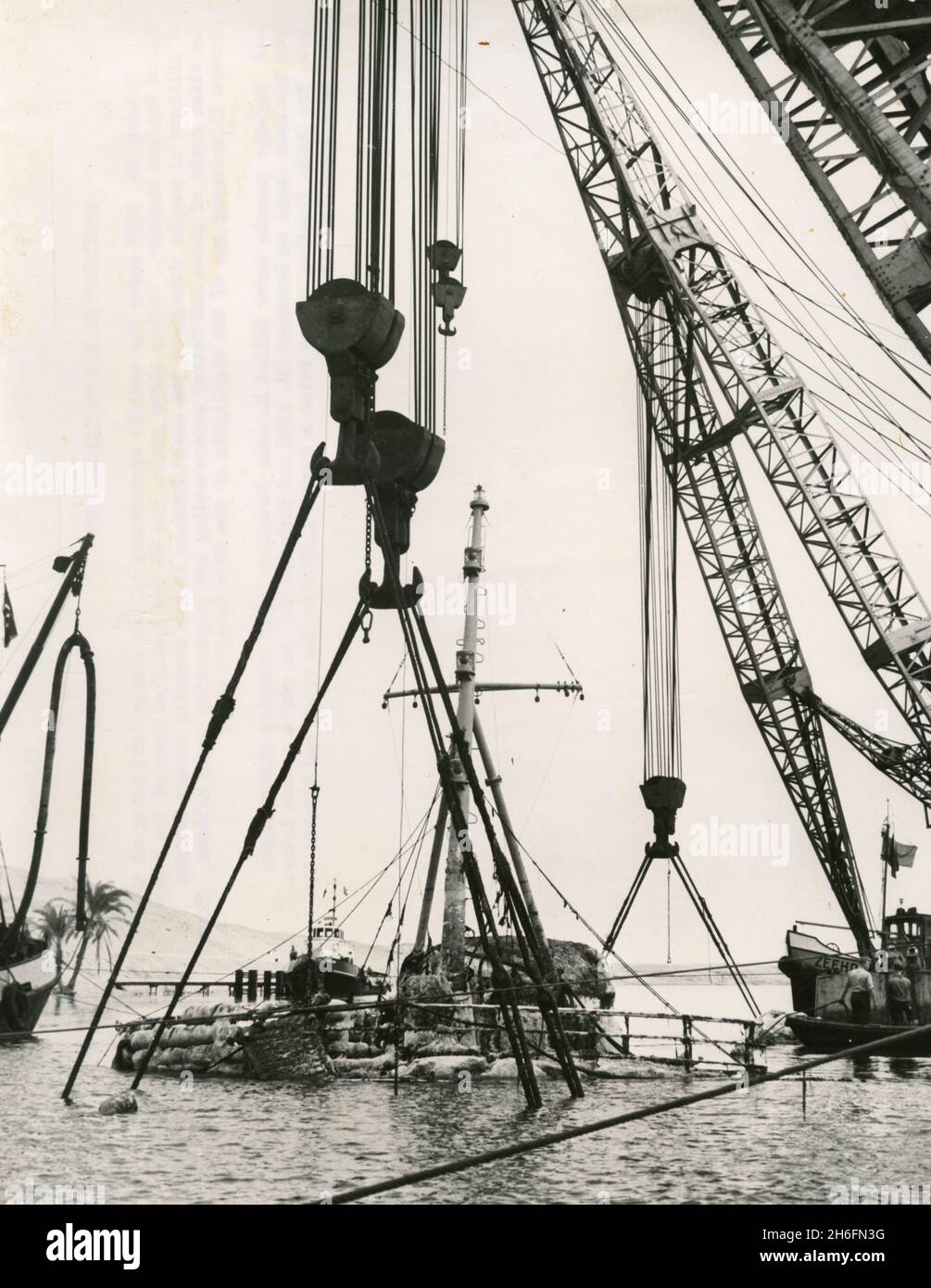 Two Dutch floating cranes raising a sunken tug boat near Ismailia at ...