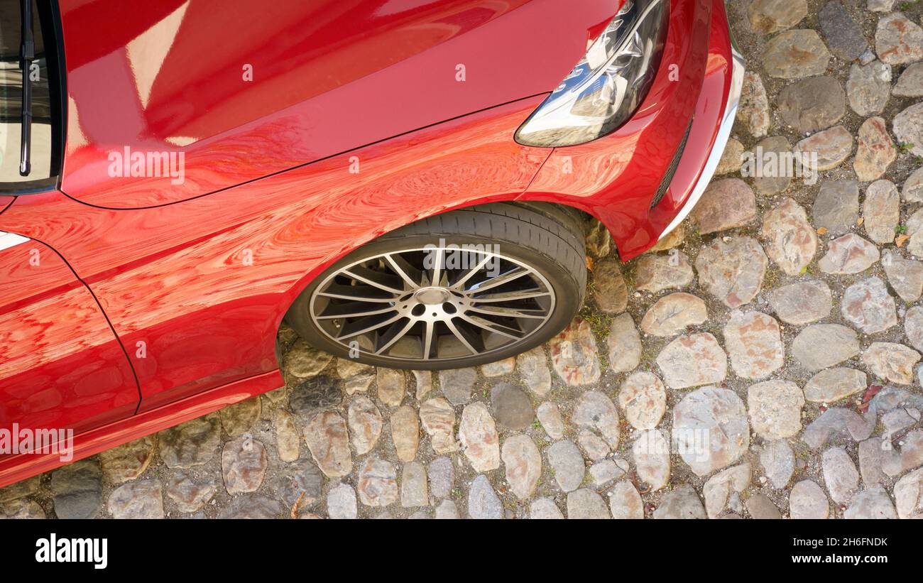 Closeup of a red car tire with cobblestone detail Stock Photo - Alamy