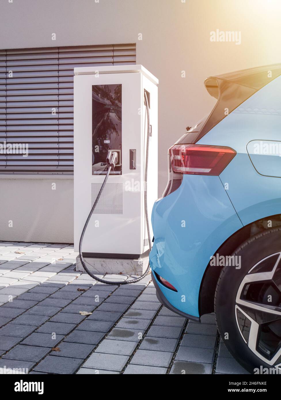 Vertical closeup of an environment-friendly electric car at a charging ...