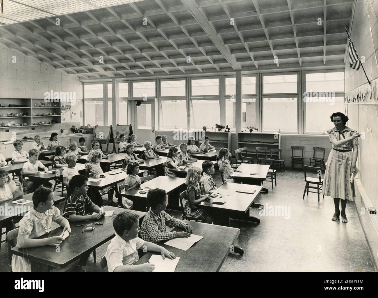 Pupils at an elementary school classroom watch their teacher ...