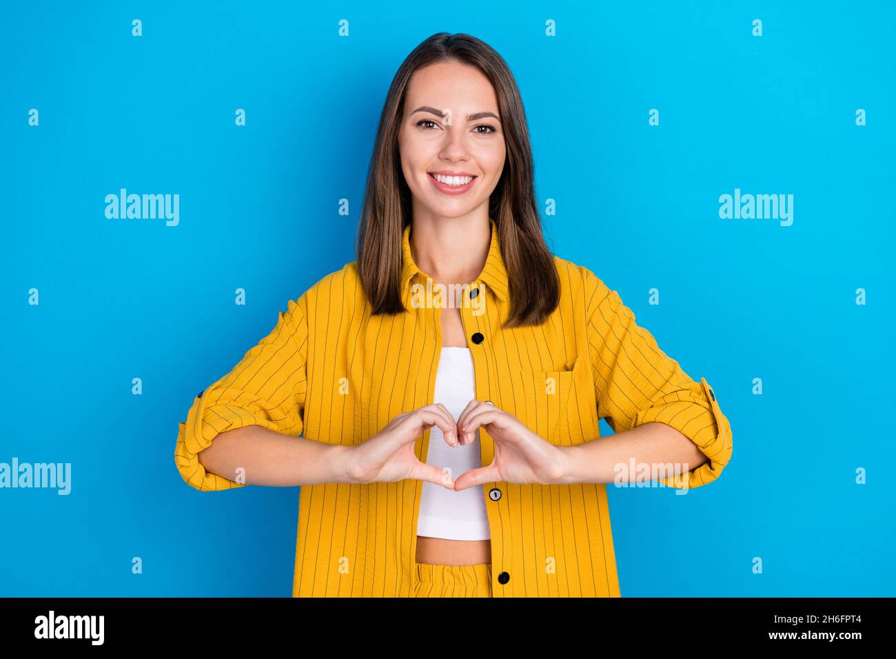 Photo of cheerful lovely young woman make fingers heart shape romantic ...