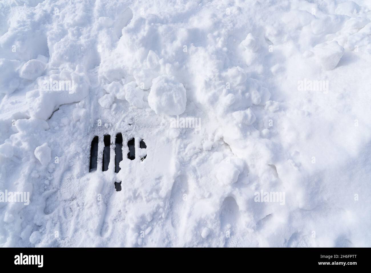 Closeup shot of a Gully on a snow-covered road Stock Photo - Alamy