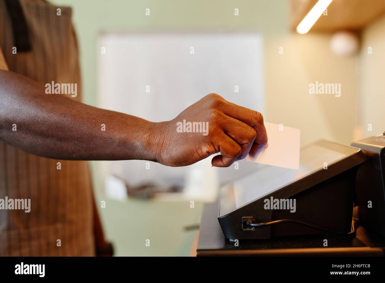 Horizontal side view shot of unrecognizable cafe worker adding ...