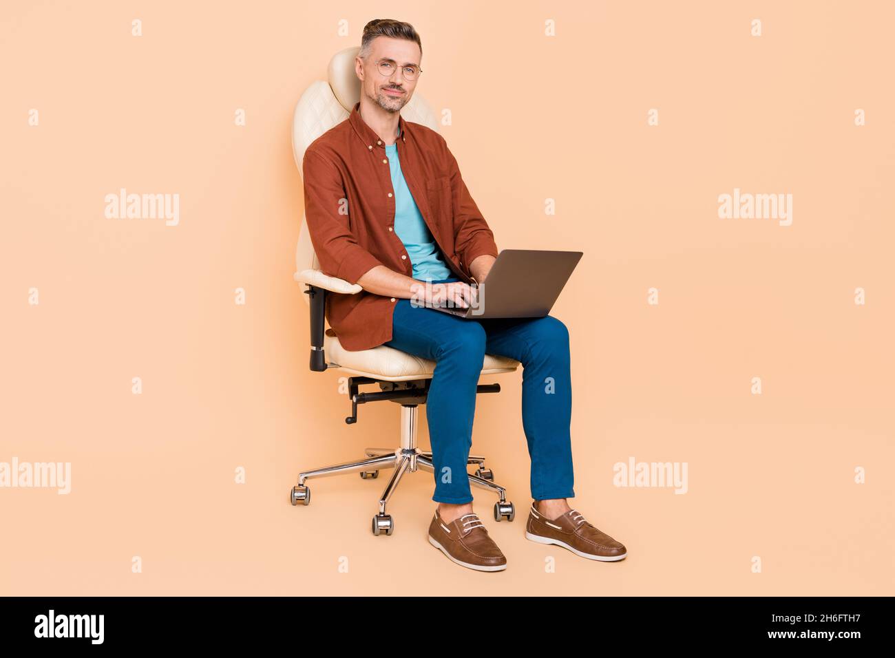 Full length photo of marketer guy sit leather chair use app netbook ...