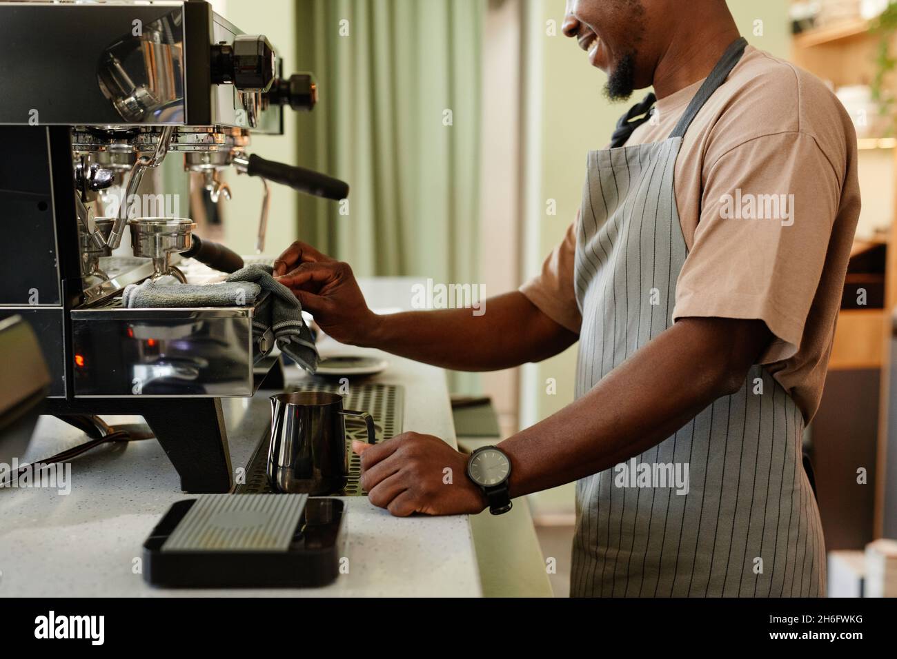 Horizontal side view shot of young African American man working as ...
