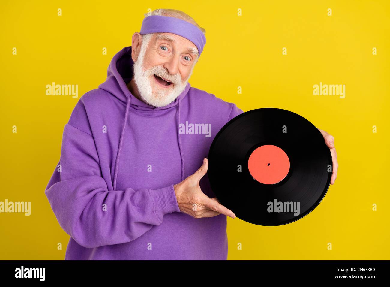 Photo of cheerful senior man good mood music lover show vinyl disc ...