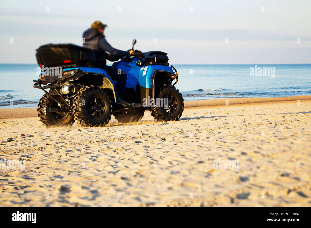 Happy ATV driver on the beach. Active recreation Stock Photo - Alamy