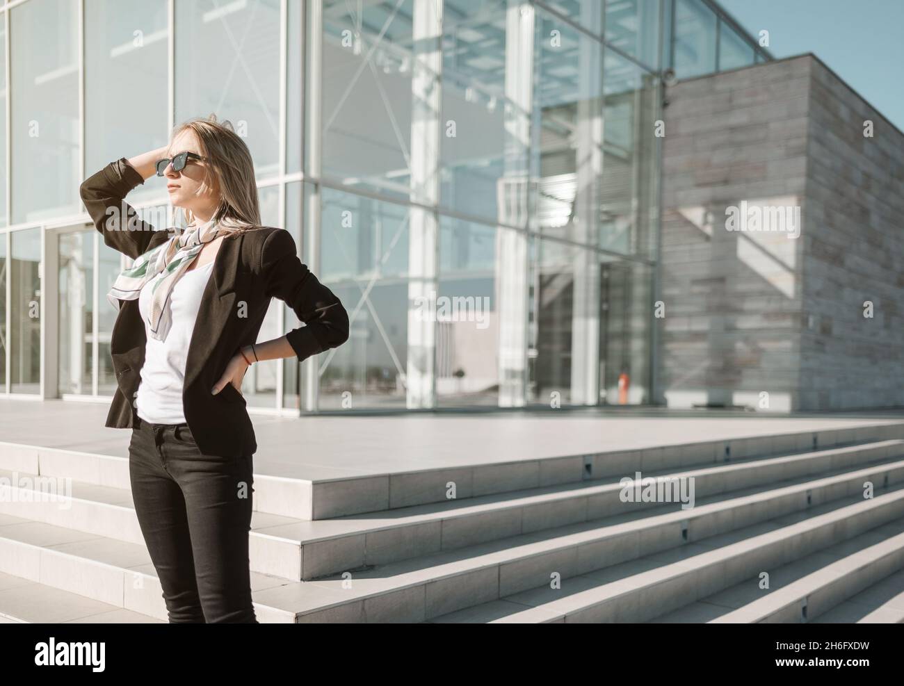 Pretty young business woman outside office building Stock Photo - Alamy