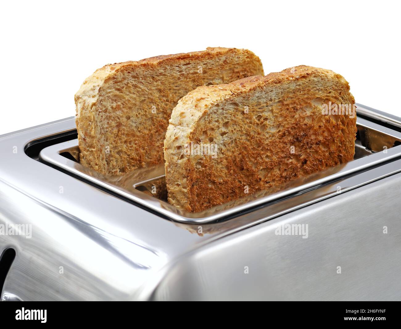 two slices of toasted wholemeal bread in silver toaster isolated on ...