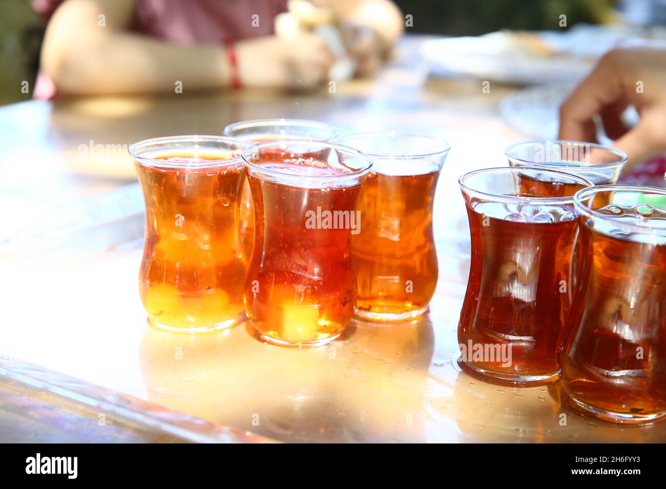 Turkish or Azerbaijani tea in pear shape glasses with saucers on ethnic ...