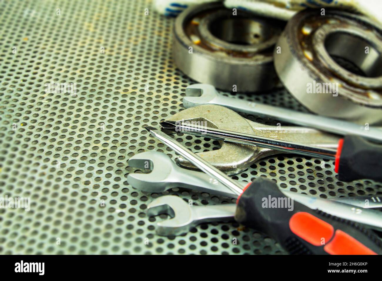 Metalworking tools, steel parts, a wrench, on the background of a metal ...