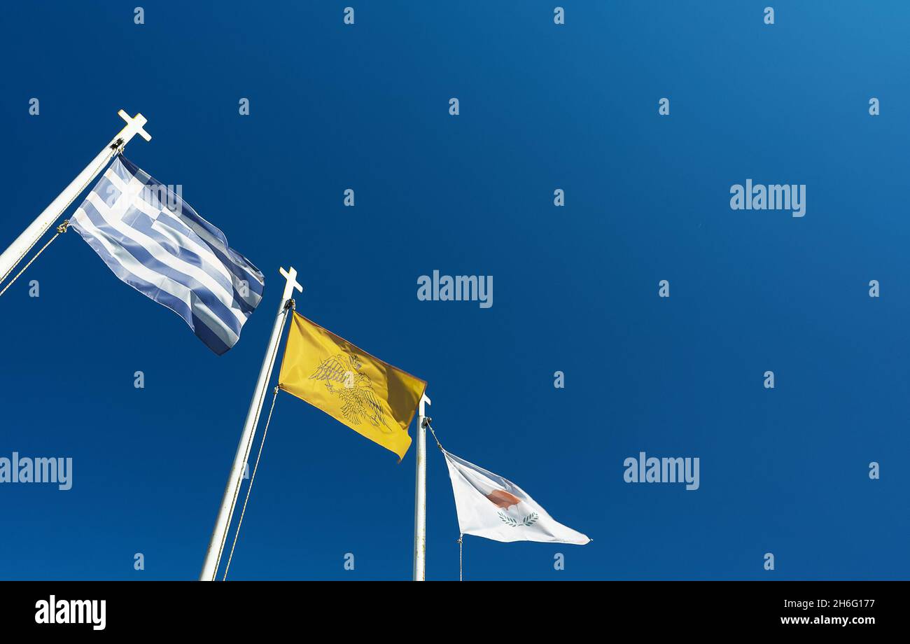 Symbols of Cyprus. Three flags - Greek, Church and Cypriot Stock Photo ...